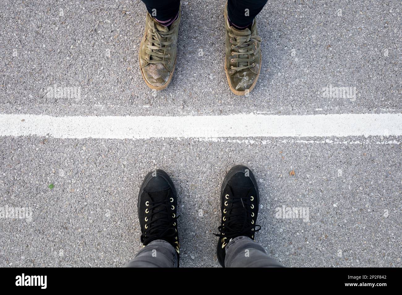Two people separated by a white line. Separation, border Stock Photo ...