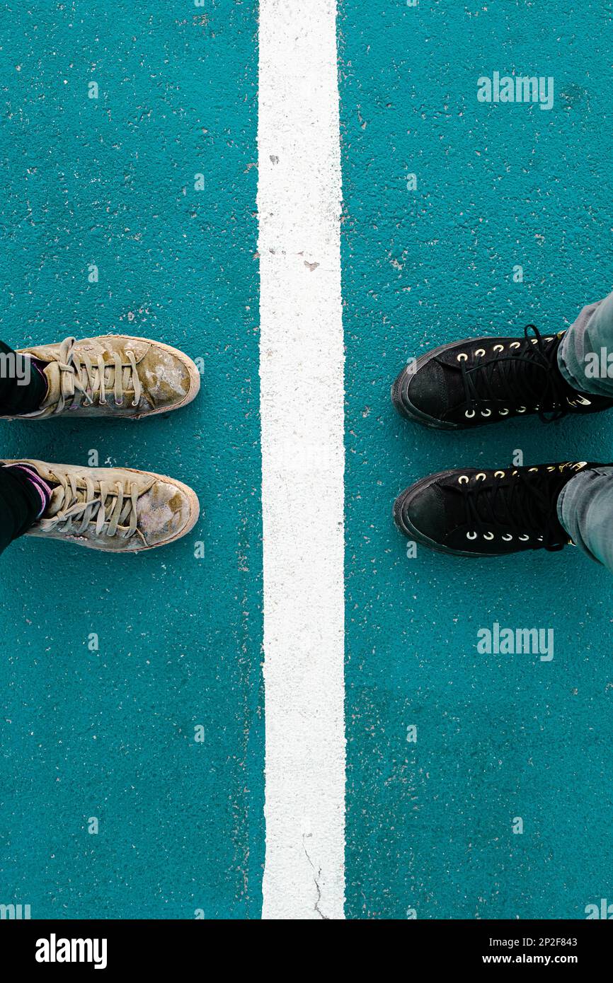 Two people separated by a white line. Separation, border Stock Photo ...