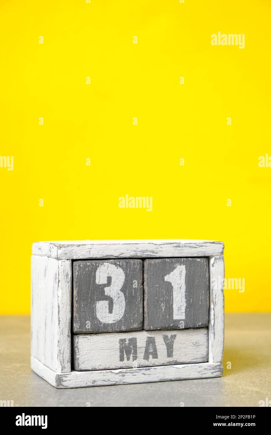 May 31 calendar made wooden cubes yellow background.With an empty space ...