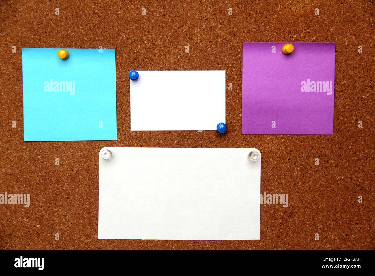 Multicolored notes for messages and reminders on cork board Stock Photo ...