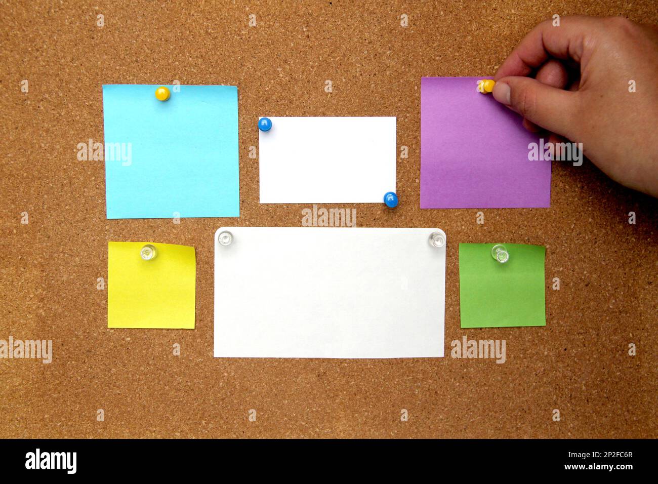 Multicolored notes for messages and reminders on cork board Stock Photo ...