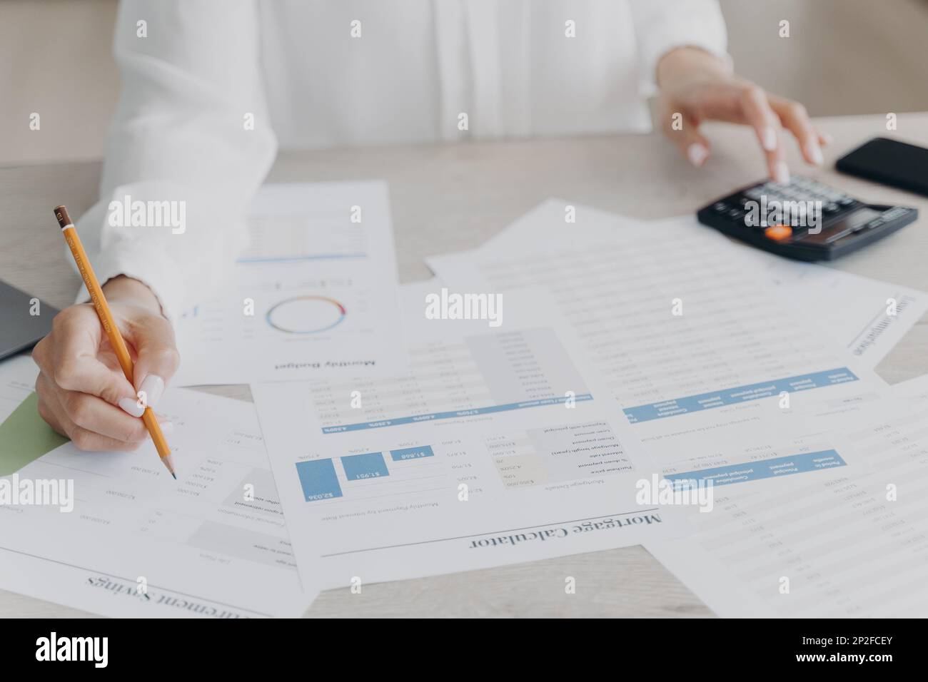 Close up of female analyzing company financial statistics shown in ...