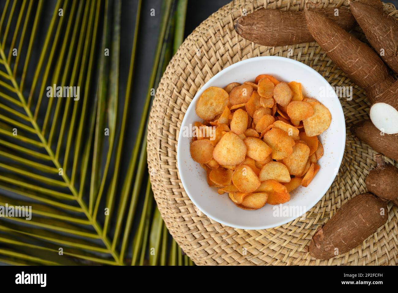 Indonesia Cassava chips in bowl and tapioca root. Popular hot spicy ...
