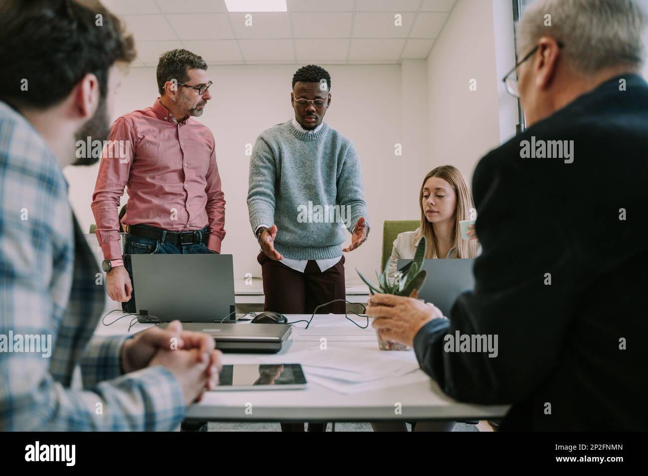 Work employee trying to get everyone’s attention and show them ...