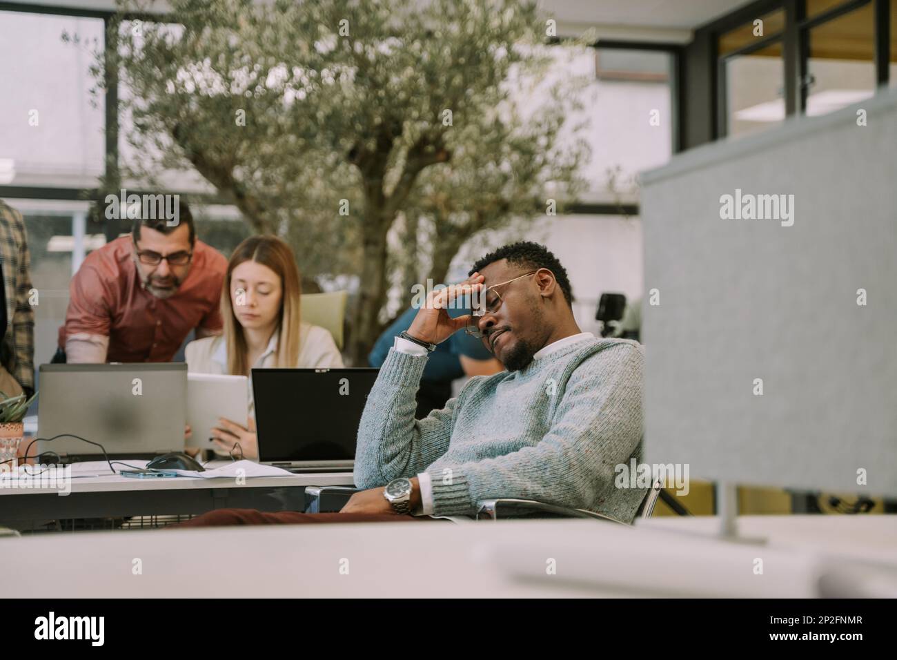 An attractive black worker is out of energy. He felt asleep after rough ...