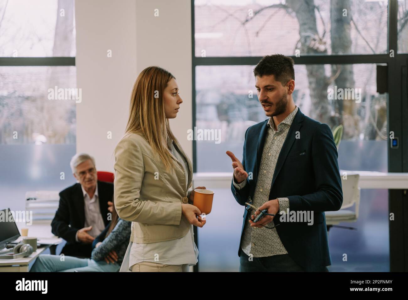 Consultation between two young colleagues at work Stock Photo - Alamy