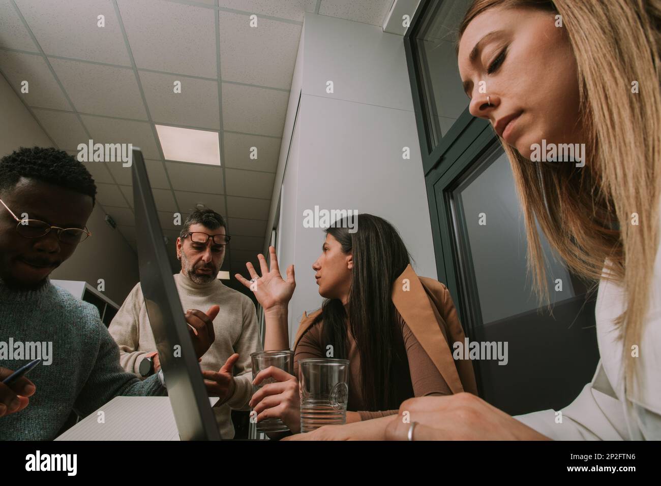 Inter-generational, multiracial group of creative people discussing and ...