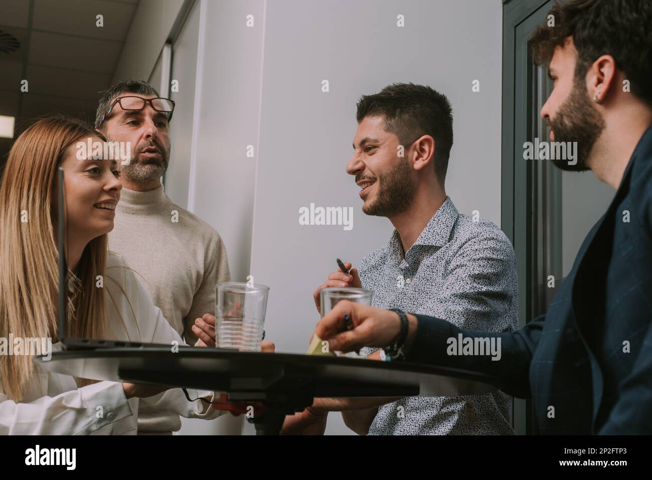 Four inter-generational group of people having fun conversation and ...