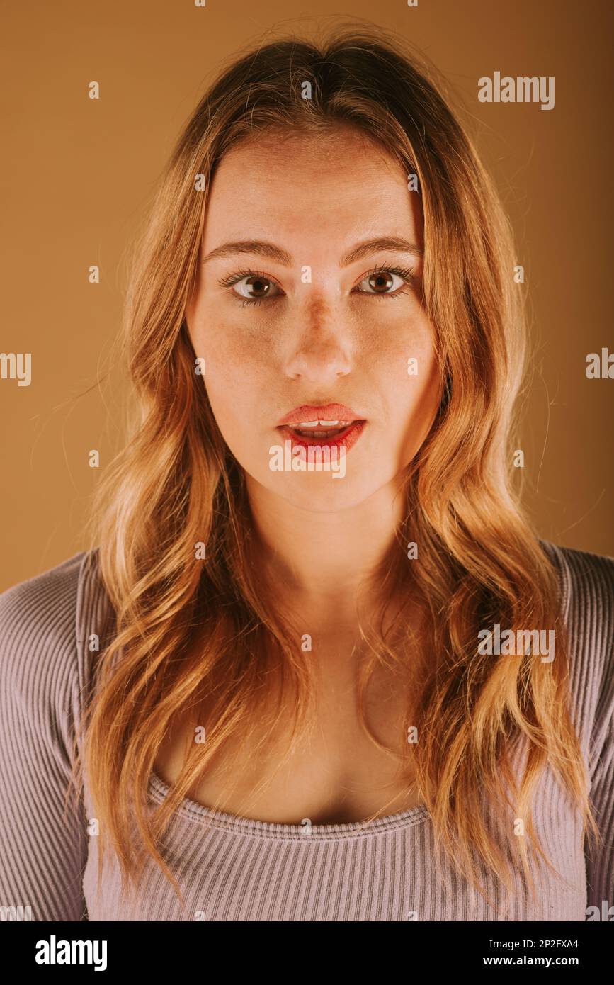 Portrait of a beautiful girl with freckles posing at the studio Stock ...