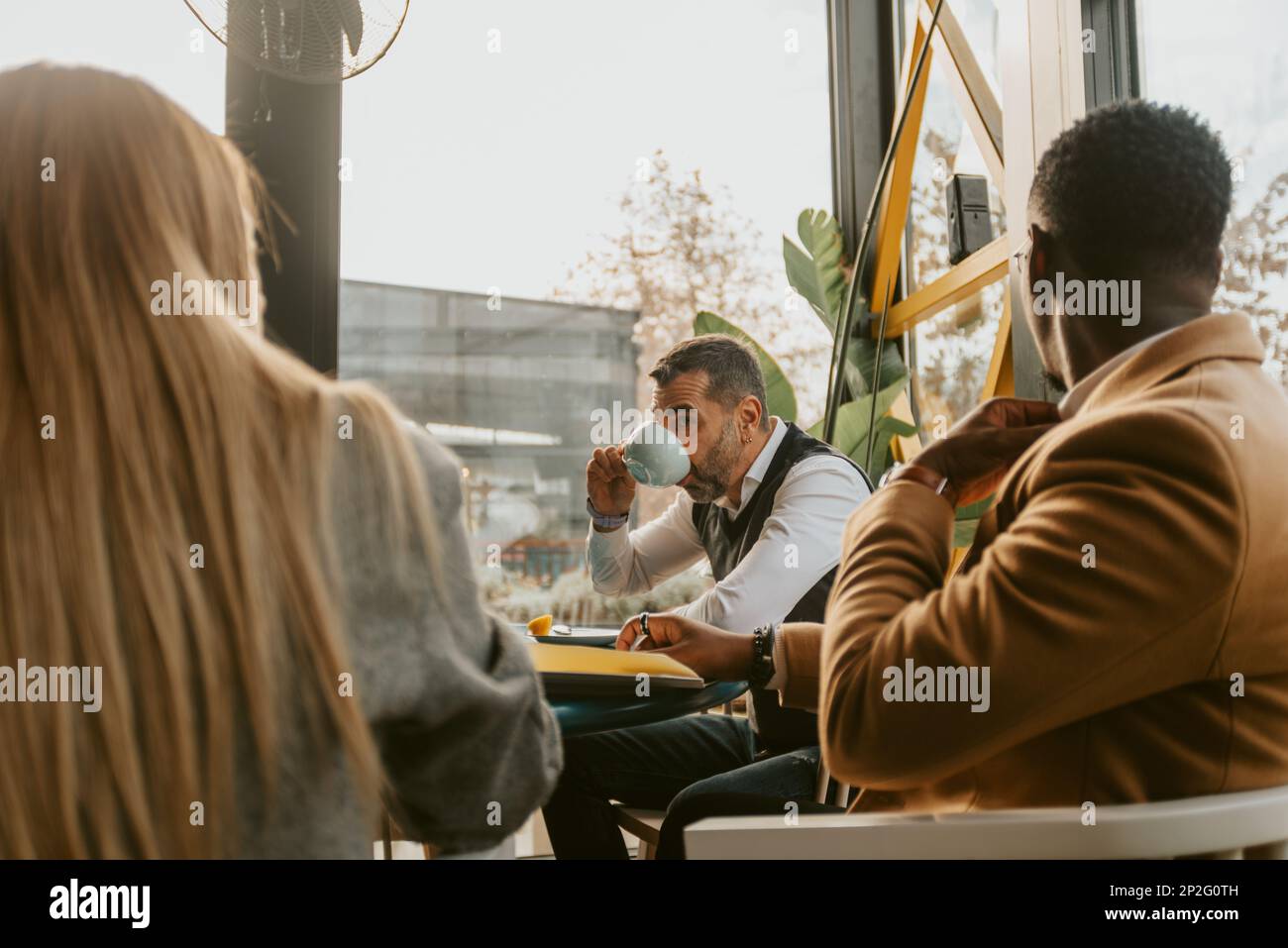 Older handsome business man drinking tea while siting with his ...