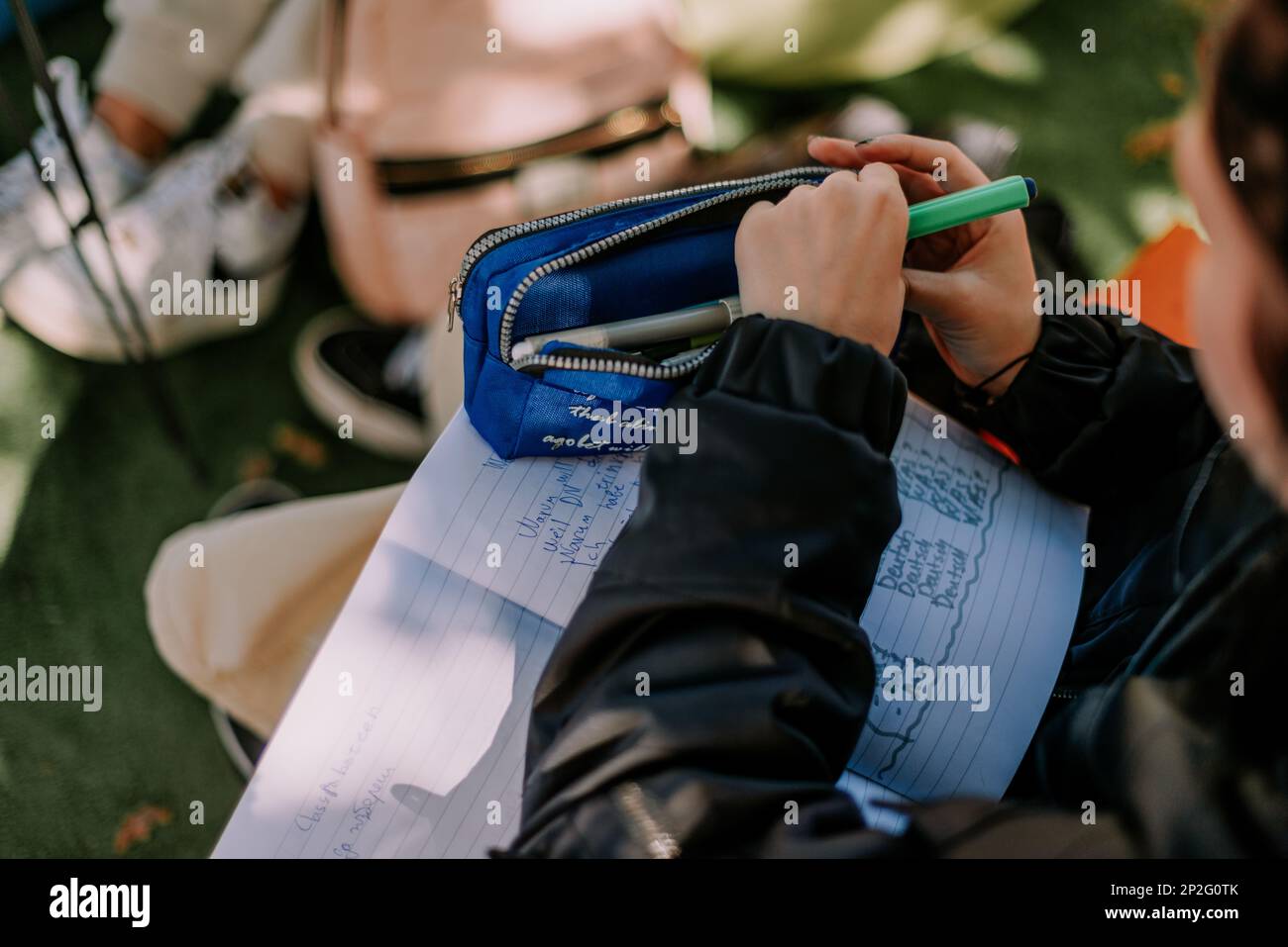 Girl is switching pens. She is underlining important parts Stock Photo ...