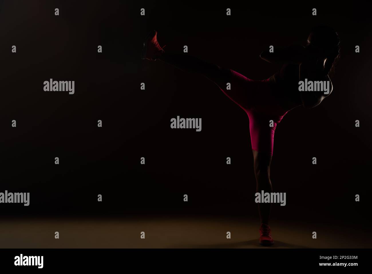 Throwing leg kicks in studio. Silhouette Stock Photo - Alamy