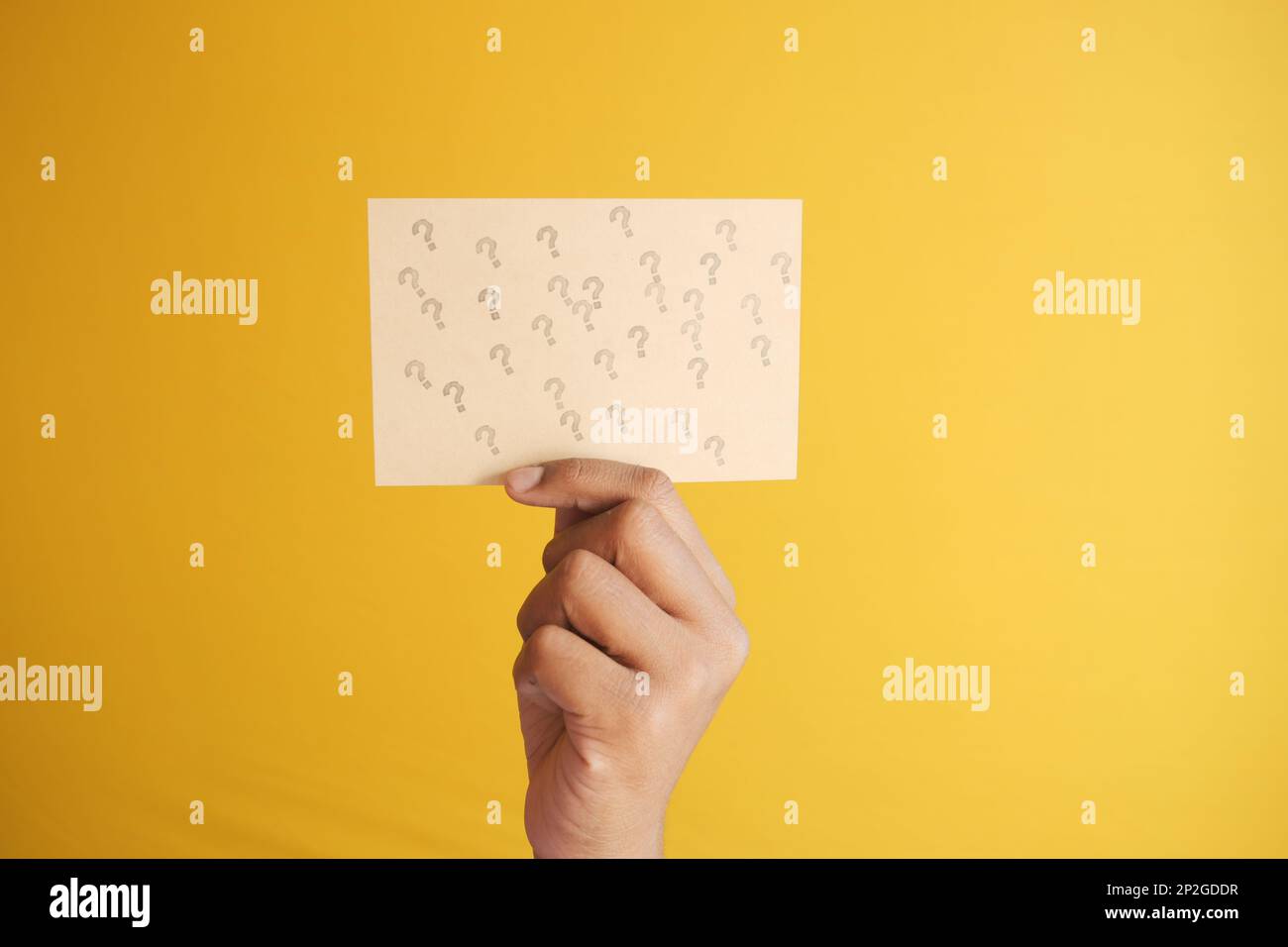 holding a paper with many question mark Stock Photo - Alamy