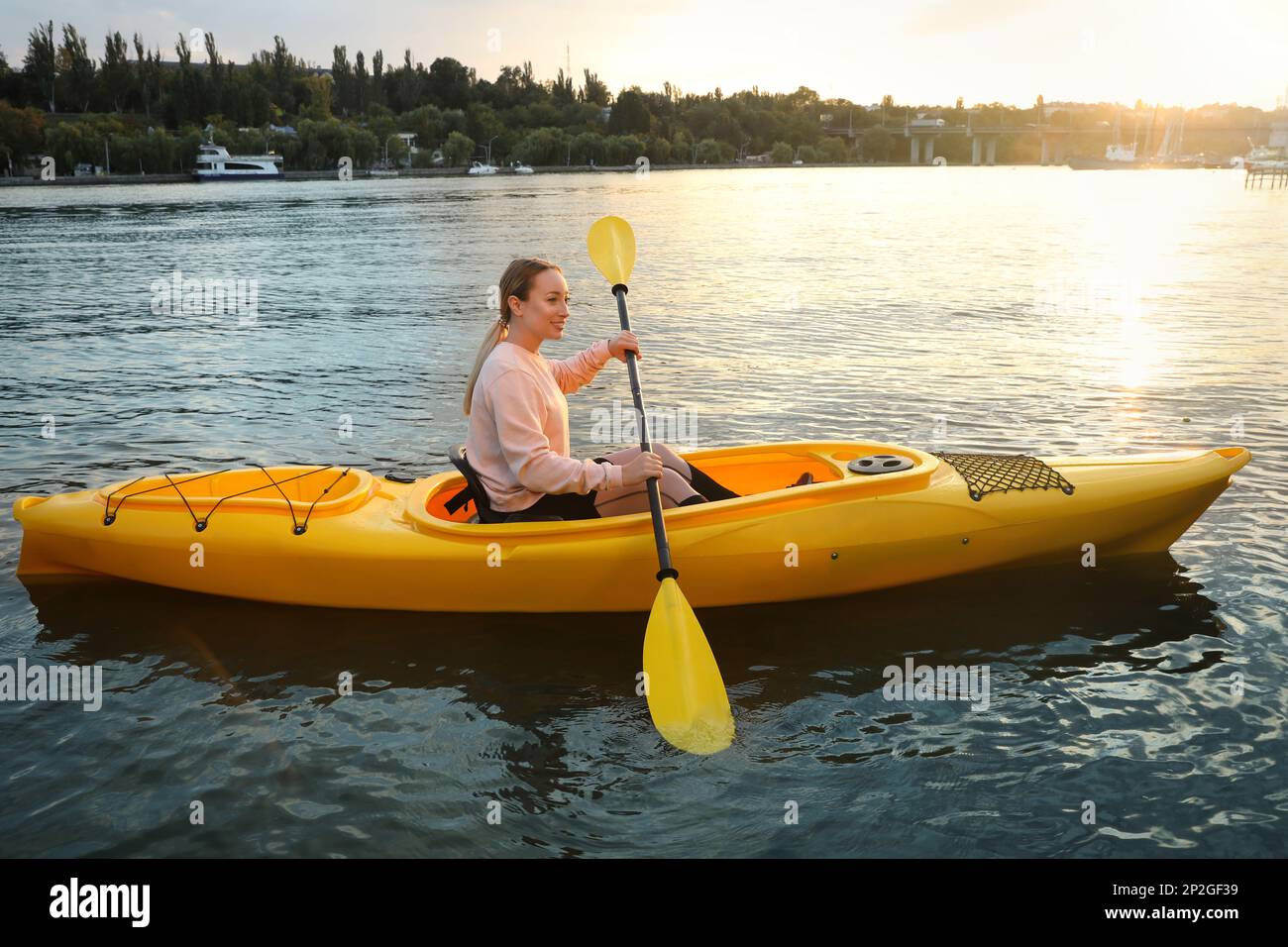 Beautiful young woman kayaking in river. Summer activity Stock Photo ...