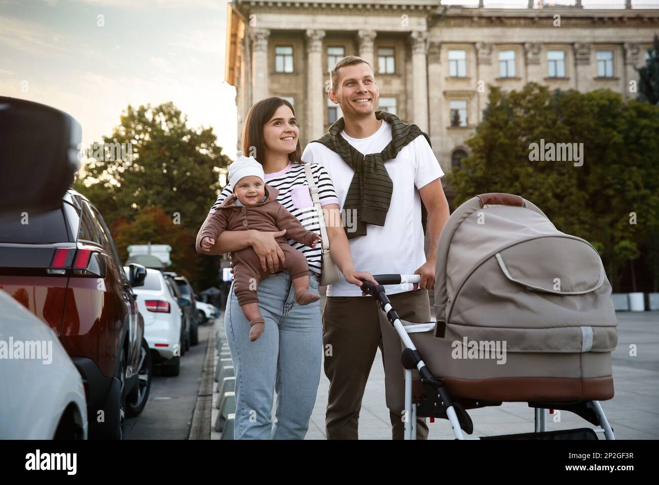 Happy parents walking with their baby outdoors Stock Photo - Alamy