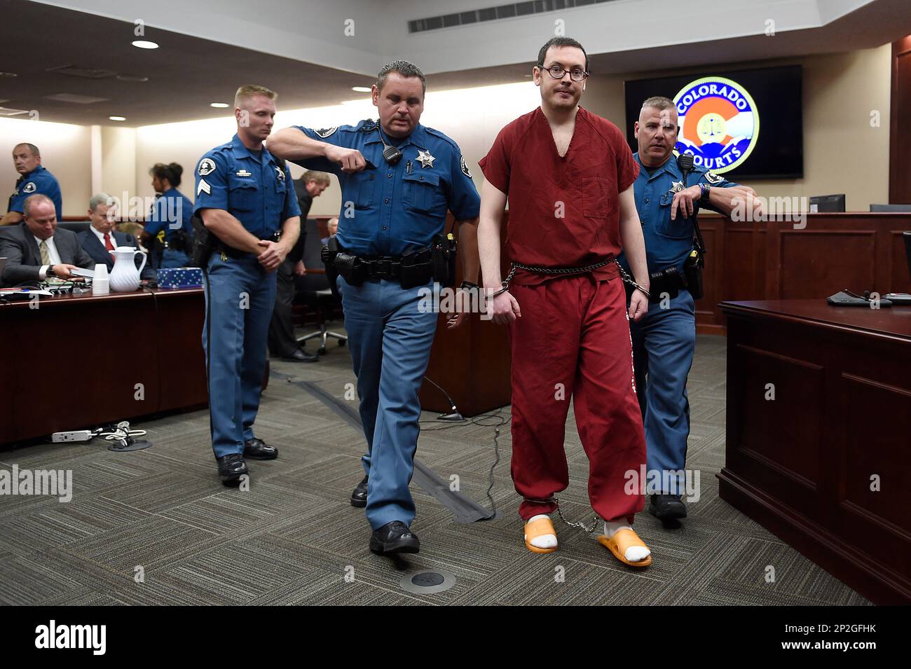 Colorado theater shooter James Holmes is led out of the courtroom after ...