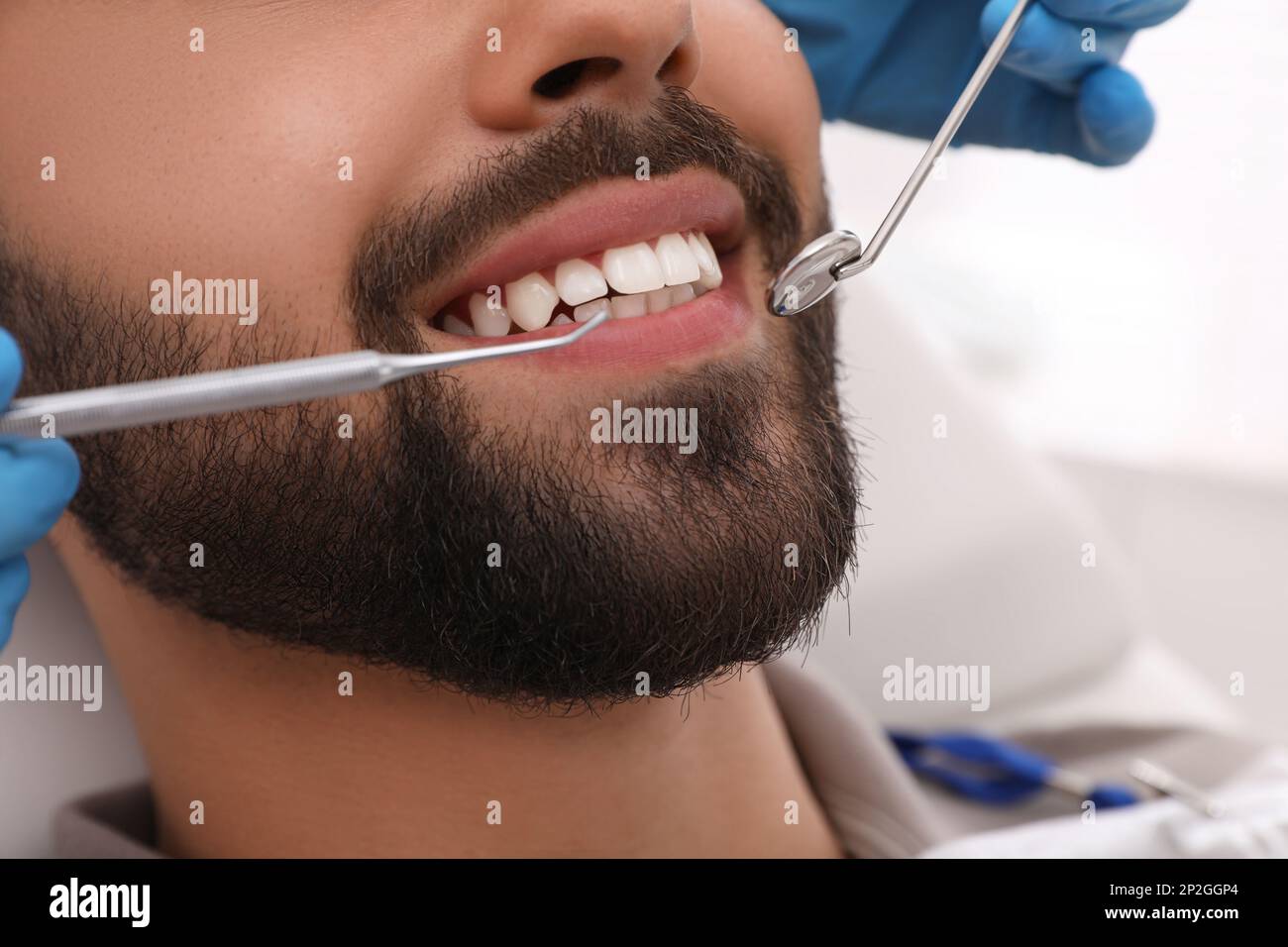 Female doctor examining mans teeth hi-res stock photography and images ...