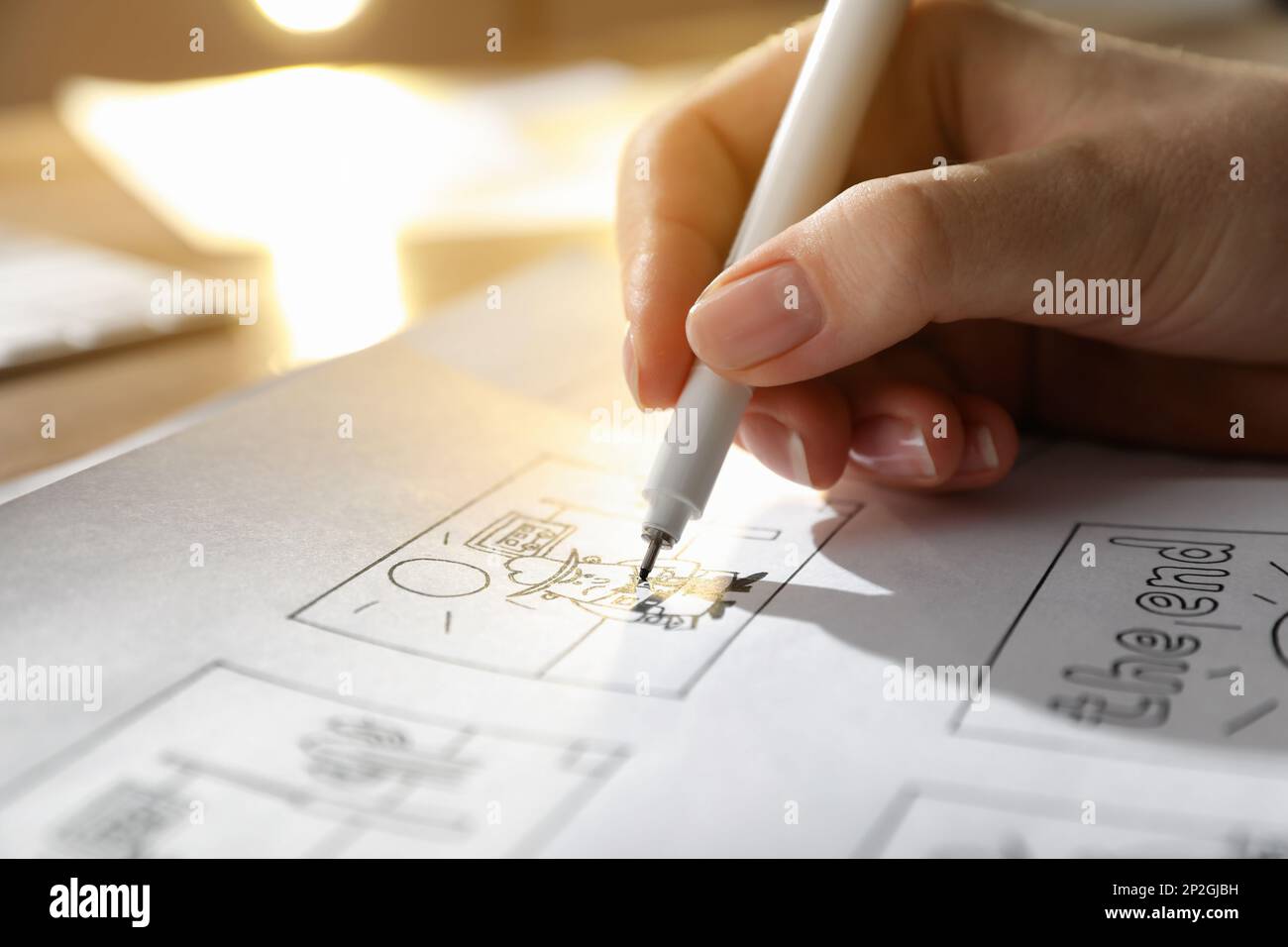 Woman drawing cartoon sketches at workplace, closeup. Pre-production ...