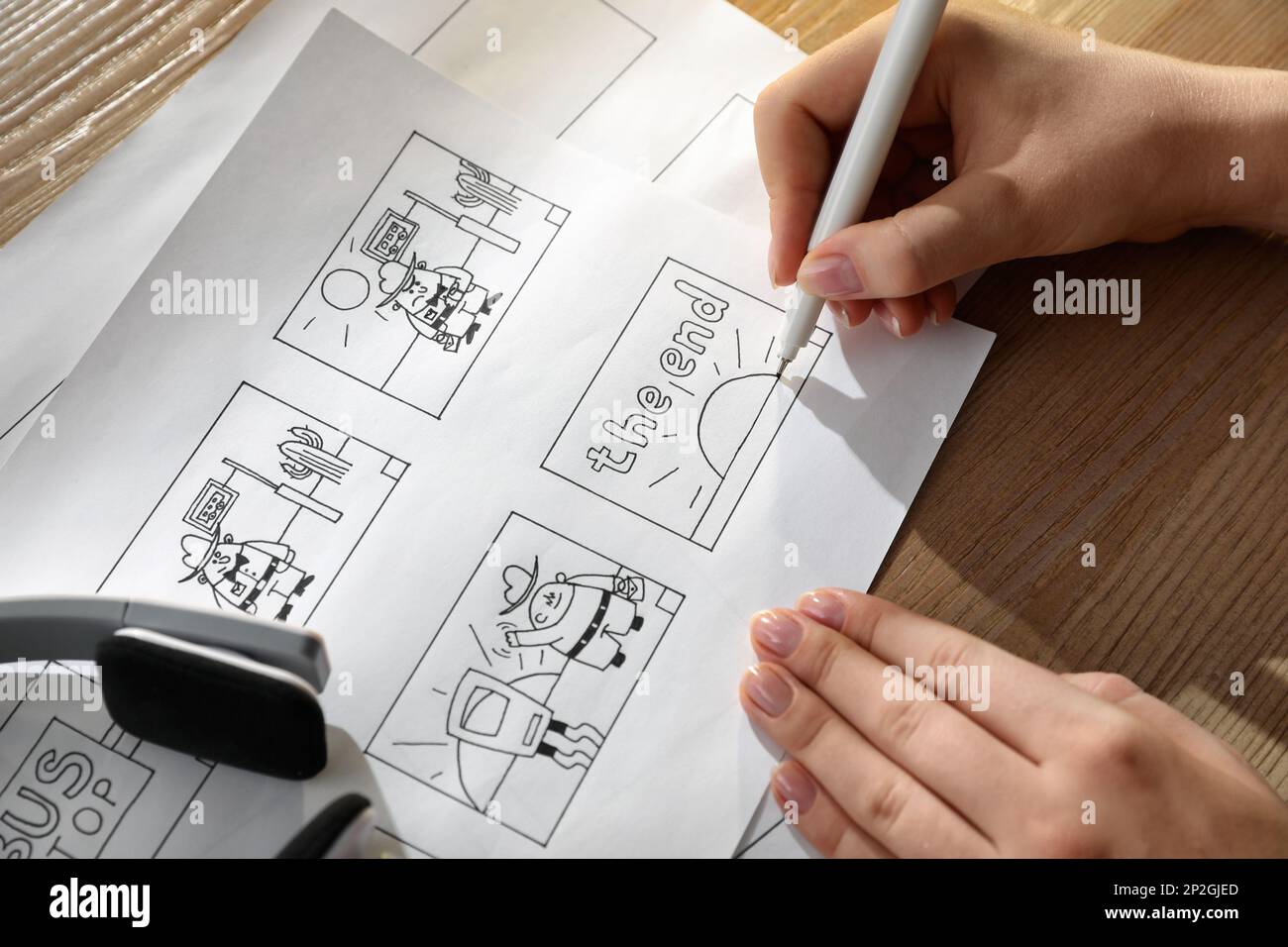 Woman drawing cartoon sketches at workplace, closeup. Pre-production ...
