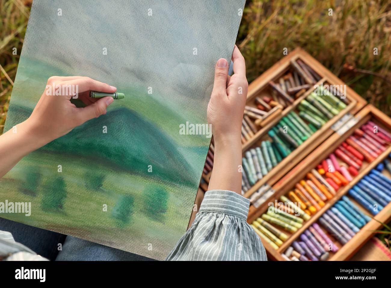 Woman drawing landscape with soft pastels outdoors, closeup Stock Photo ...