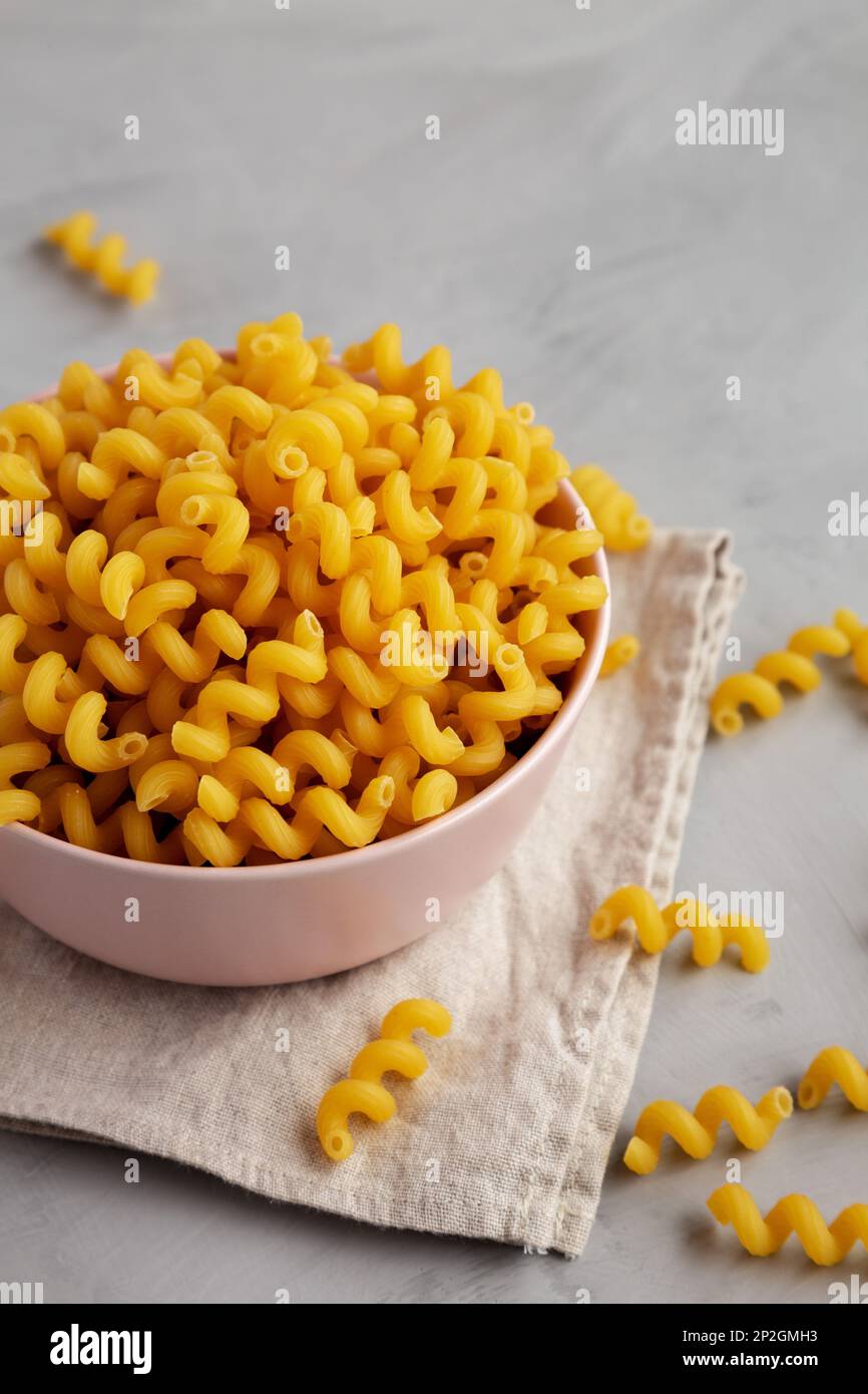 Homemade Organic Dried Riccioli Pasta in a Pink Bowl, side view Stock ...