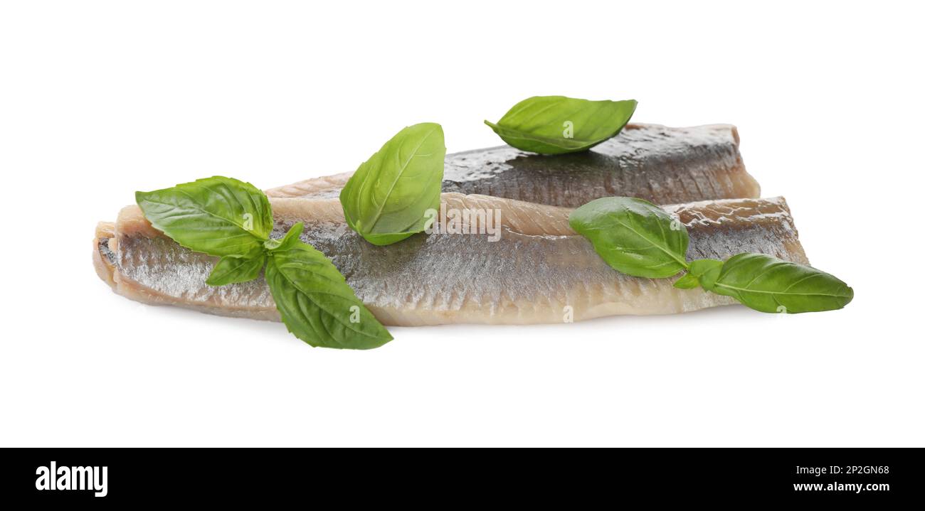Delicious salted herring fillets with basil on white background Stock ...