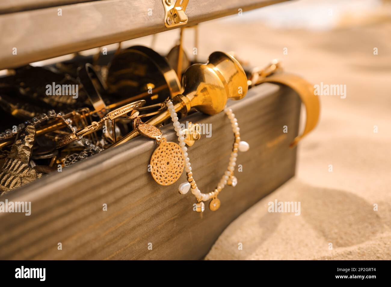 Open wooden treasure chest on sandy beach, closeup Stock Photo - Alamy