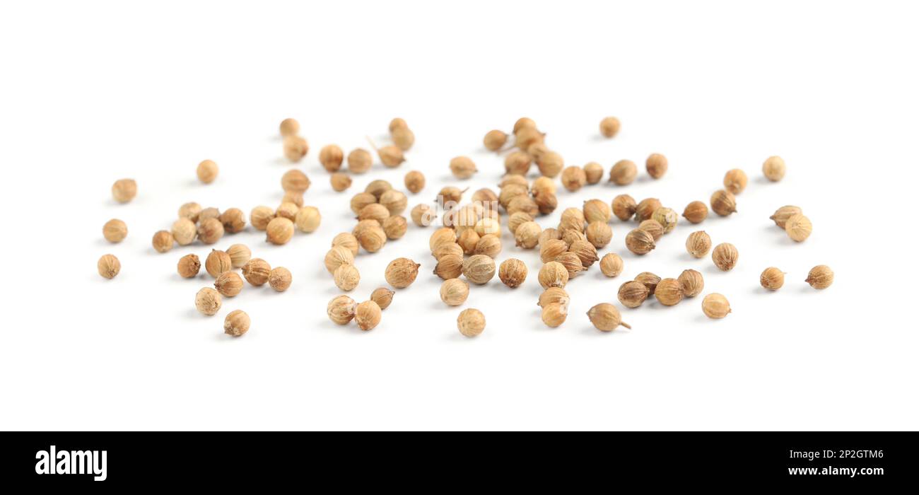 Scattered dried coriander seeds on white background Stock Photo - Alamy