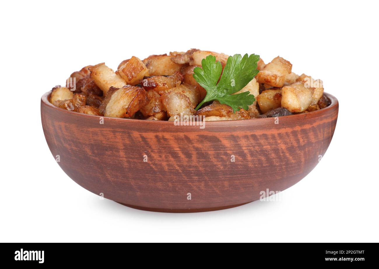 Tasty fried cracklings with parsley in bowl on white background. Cooked ...