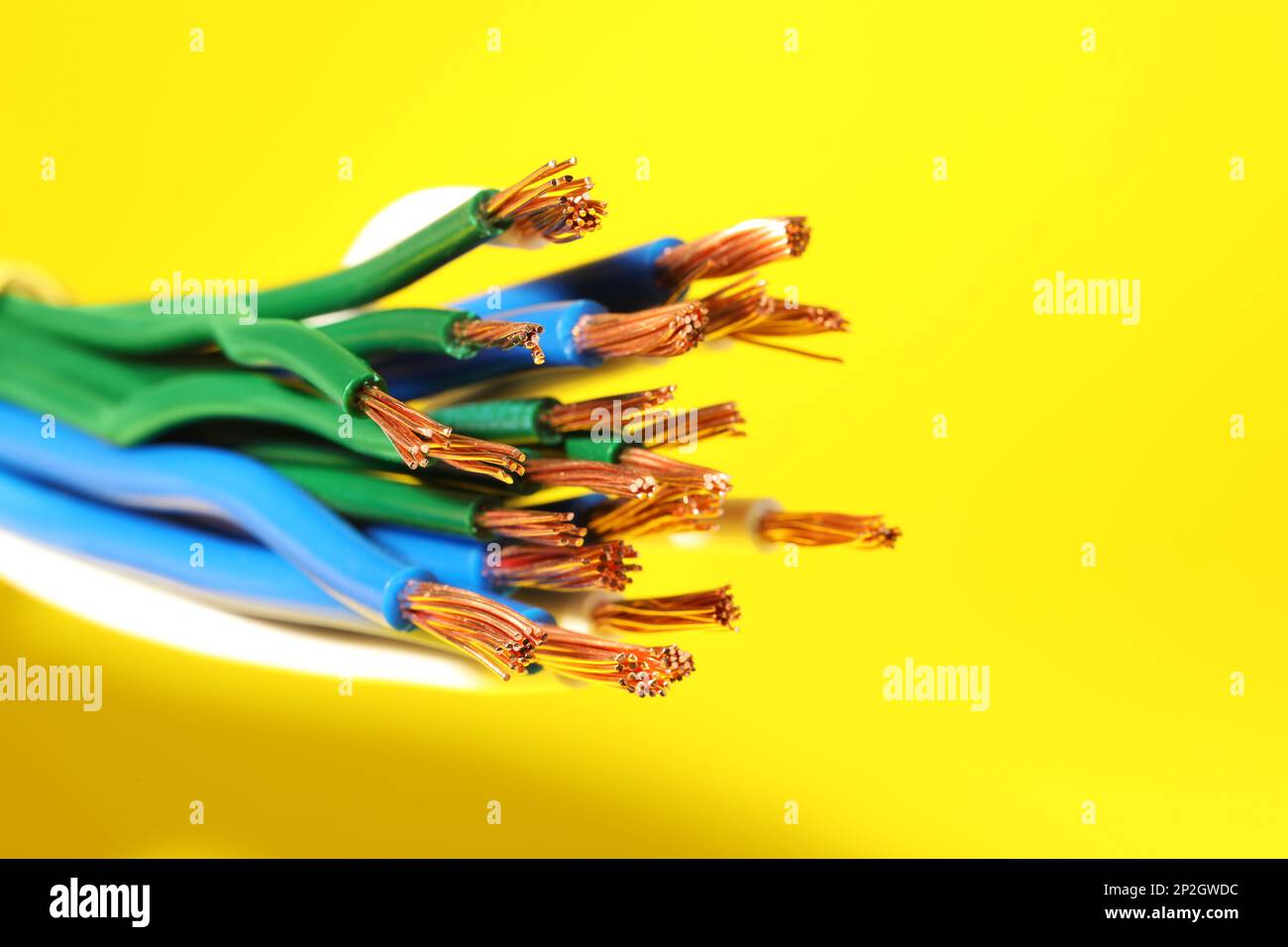 Electrical wires on yellow background, closeup. Space for text Stock ...