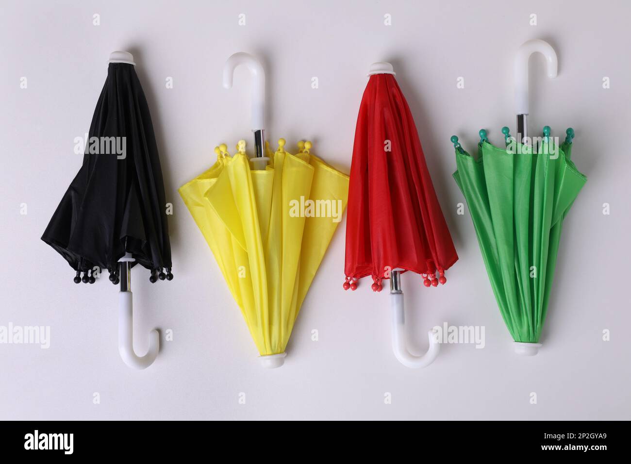 Small color umbrellas on white background, top view Stock Photo - Alamy