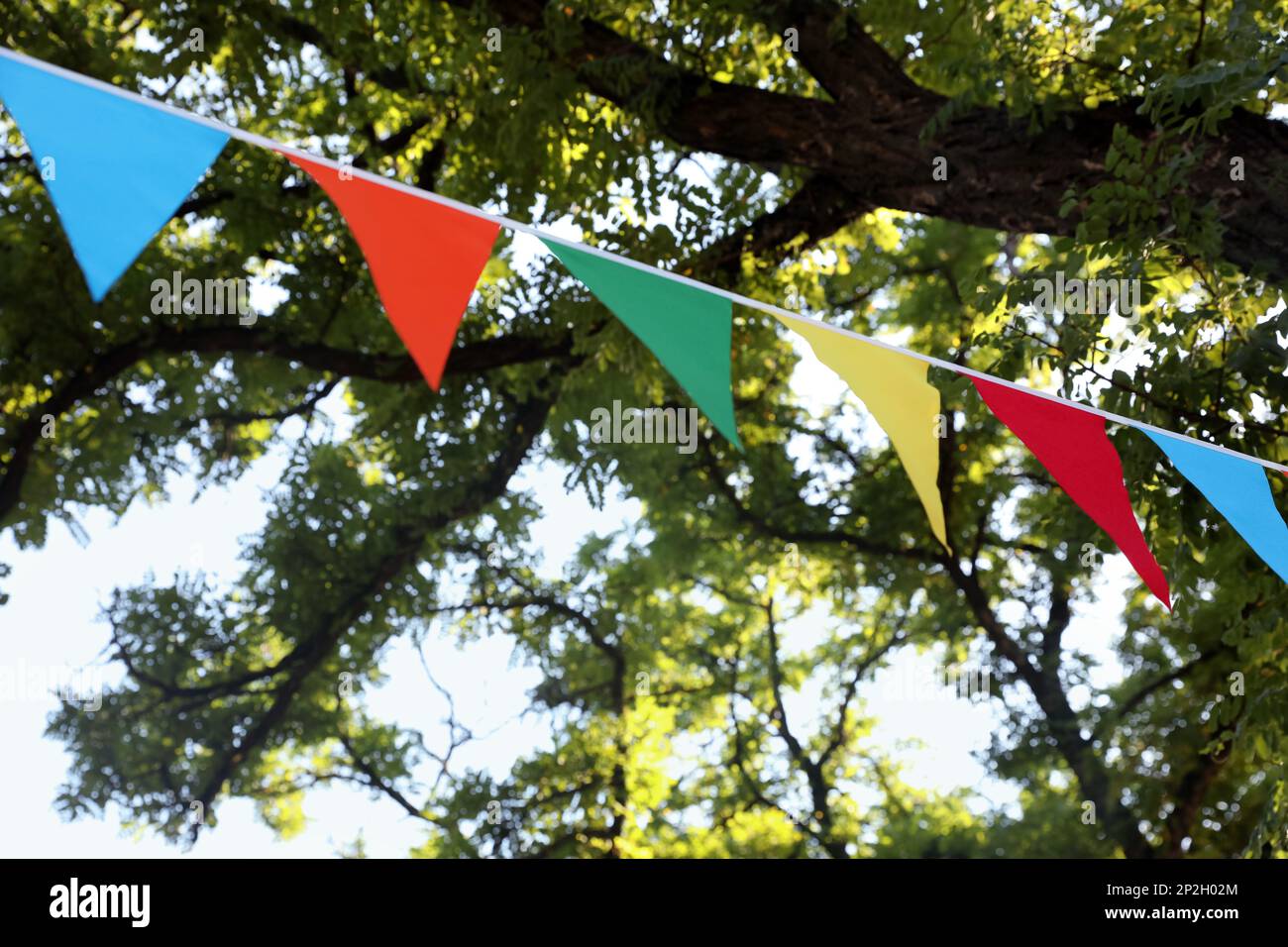 Colorful bunting flags in park. Party decor Stock Photo - Alamy