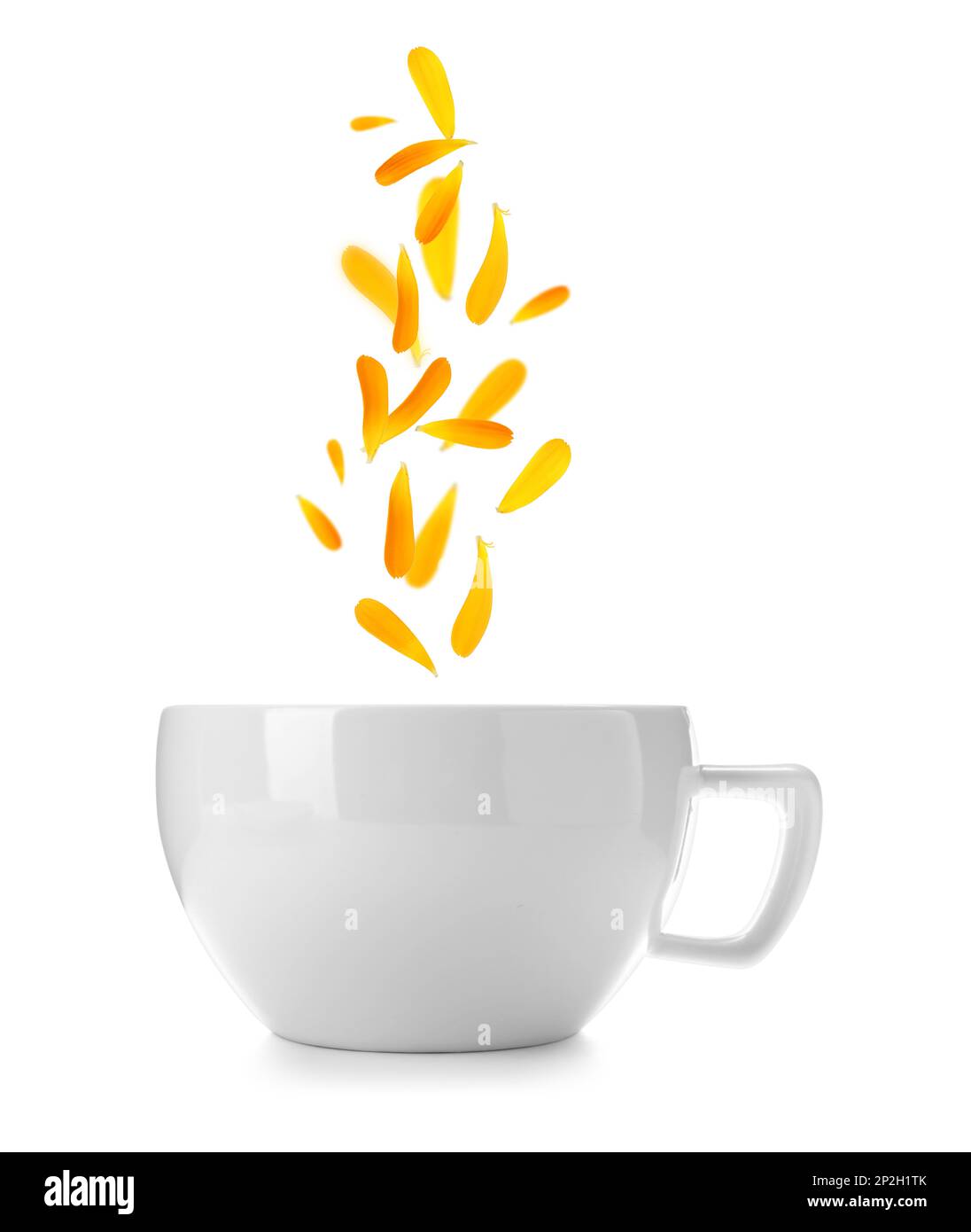 Beautiful calendula petals falling into cup of freshly brewed tea on ...