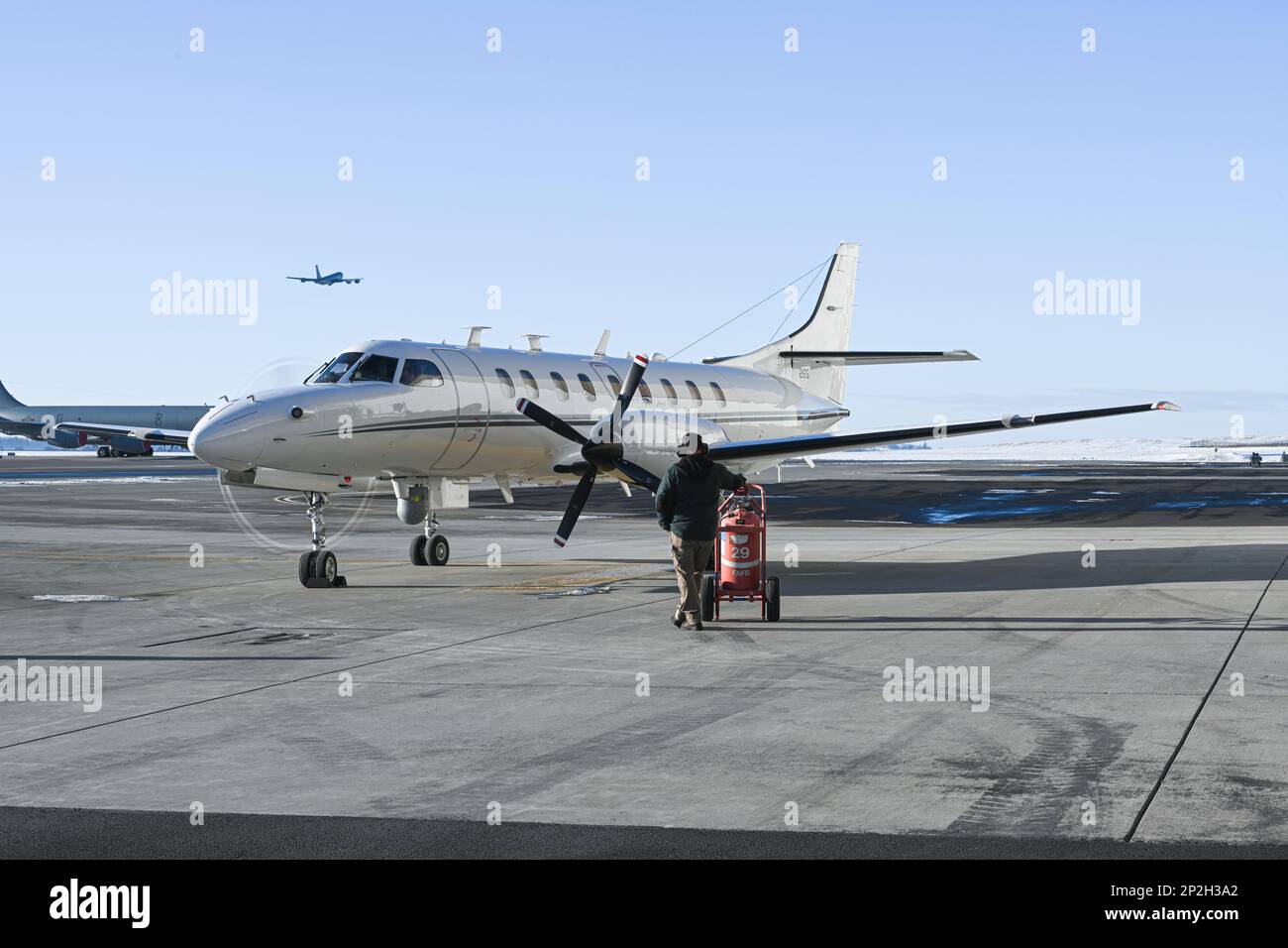 Mr. John King, RC-26 Program Aircraft Maintainer leans on a fire bottle ...