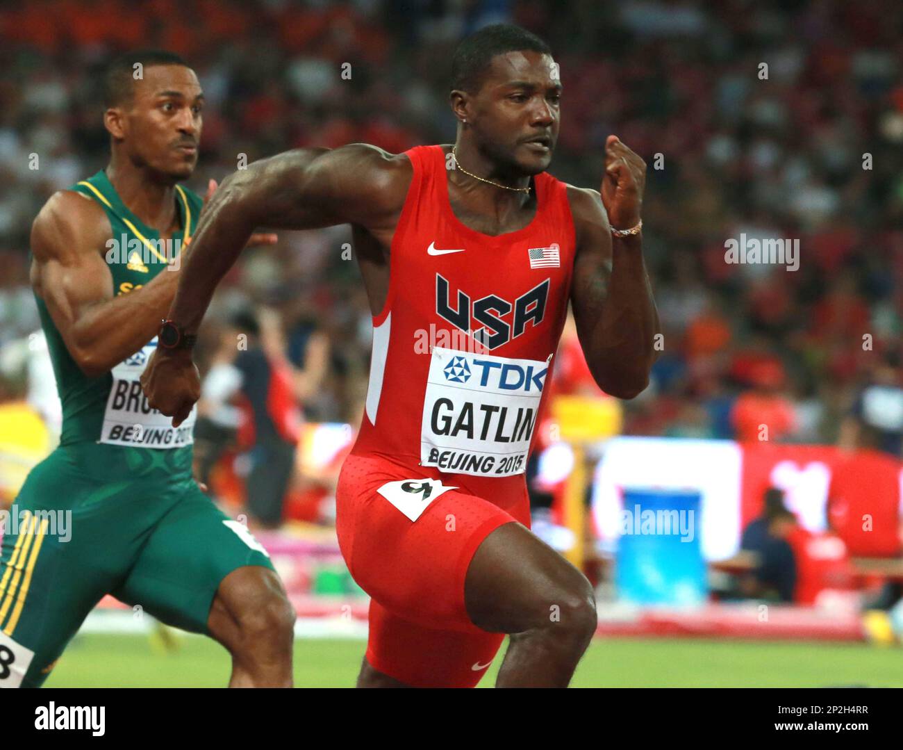 Justin Gatlin of U. S. A. (R) competes during the men's 100m heat on ...