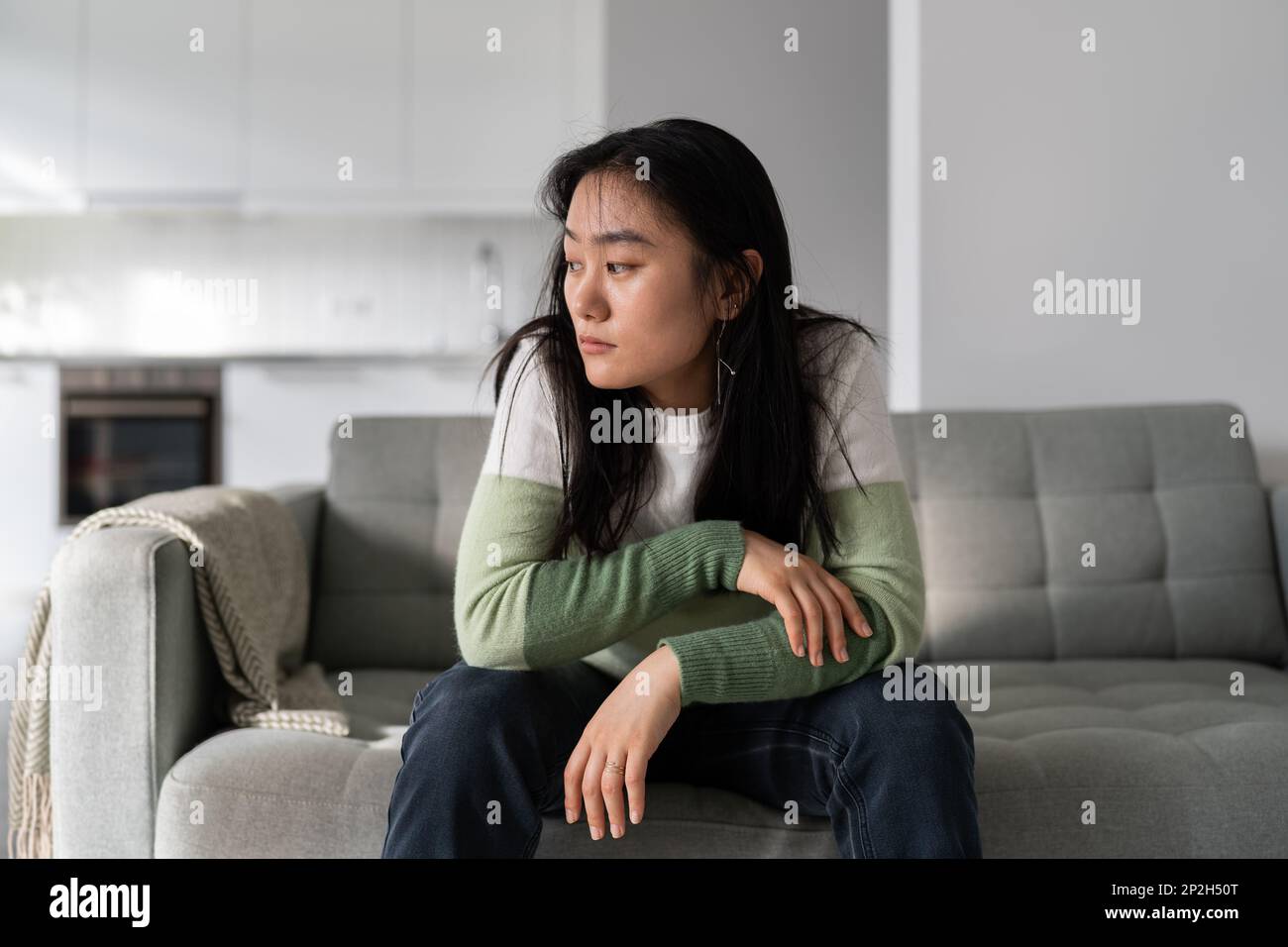 Sad lonely young Asian woman having depression symptoms worrying about ...