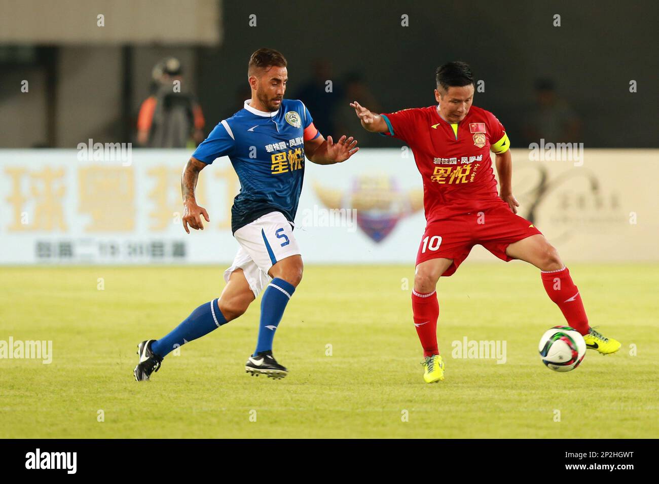 Fabio Cannavaro of the European Legends Team, left, challenges Peng ...
