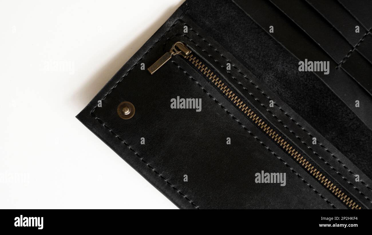Top view on open men's black empty leather wallet with a zip and lots ...