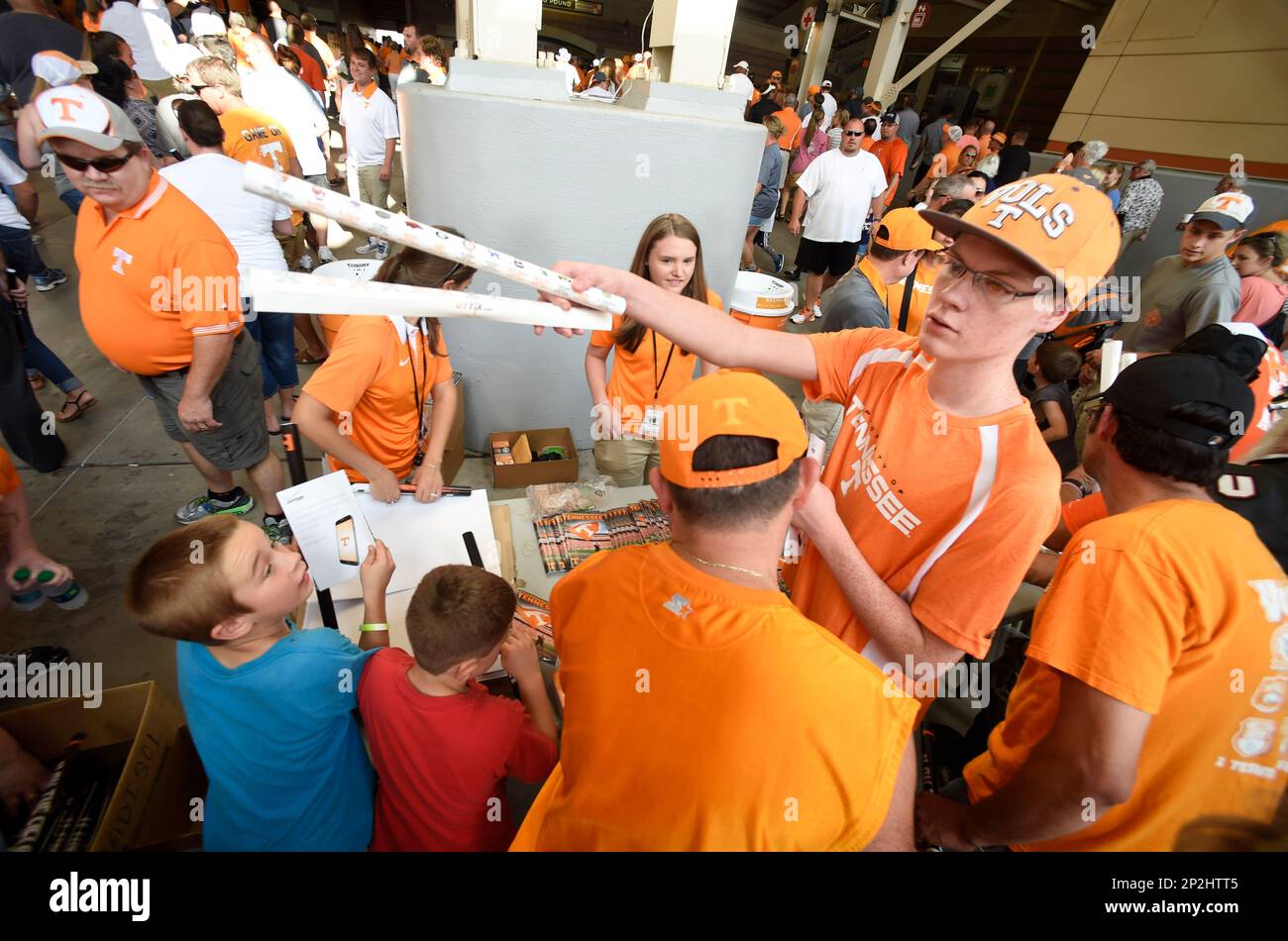 Fans crowd around a desk for souvenirs and posters as the gates open ...