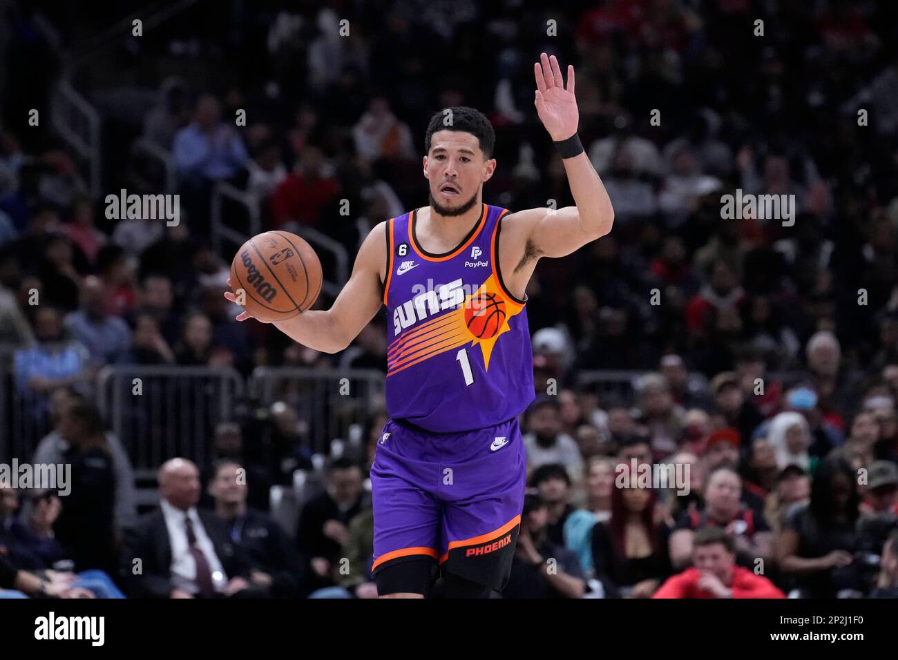 Phoenix Suns' Devin Booker signals his teammates during the first half ...