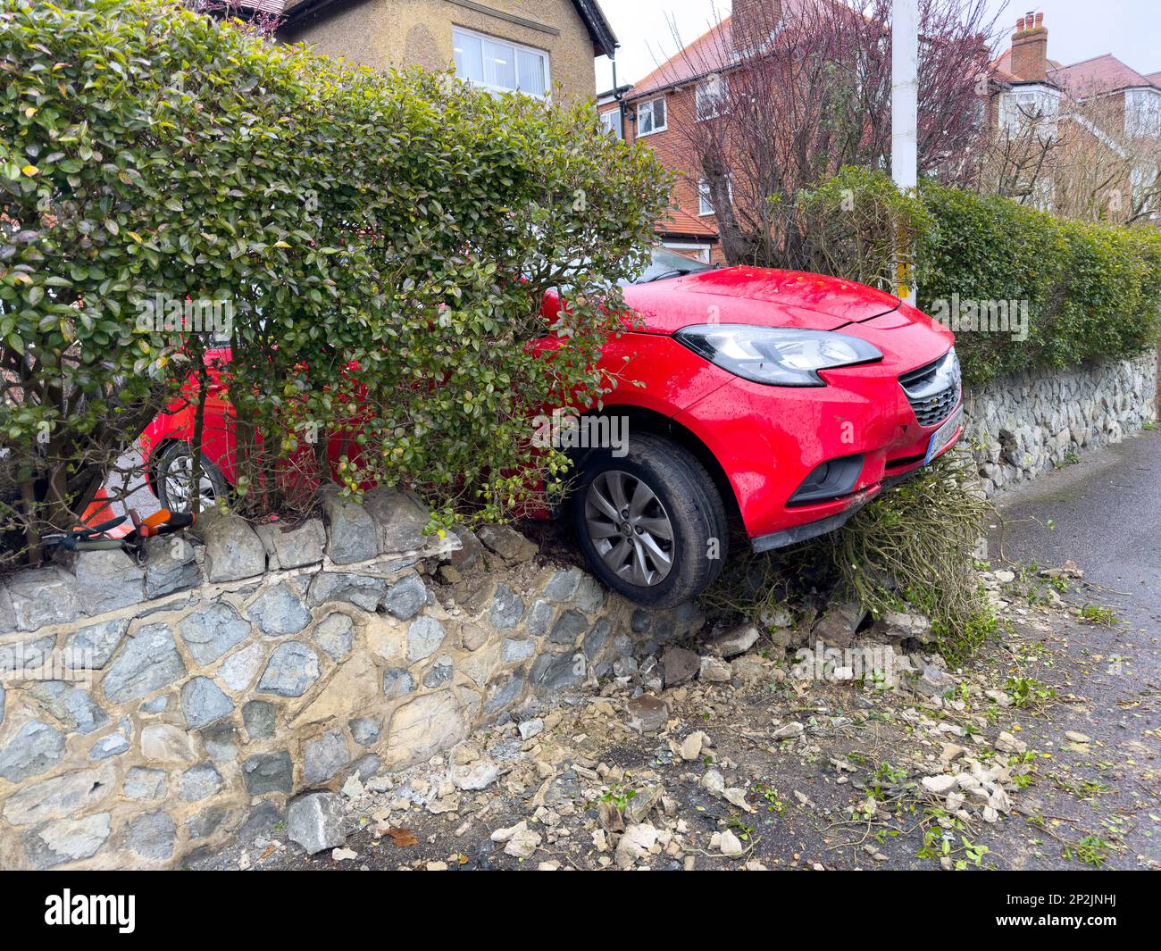 A car accident with a car having crashed through a wall Stock Photo - Alamy