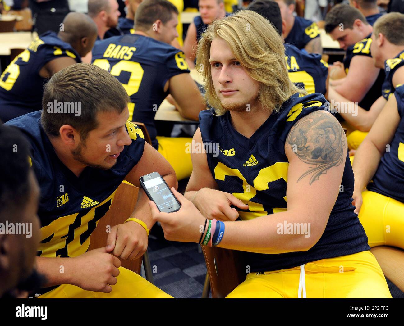 Michigan running back Wyatt Schulman, right, conducts a mock interview ...