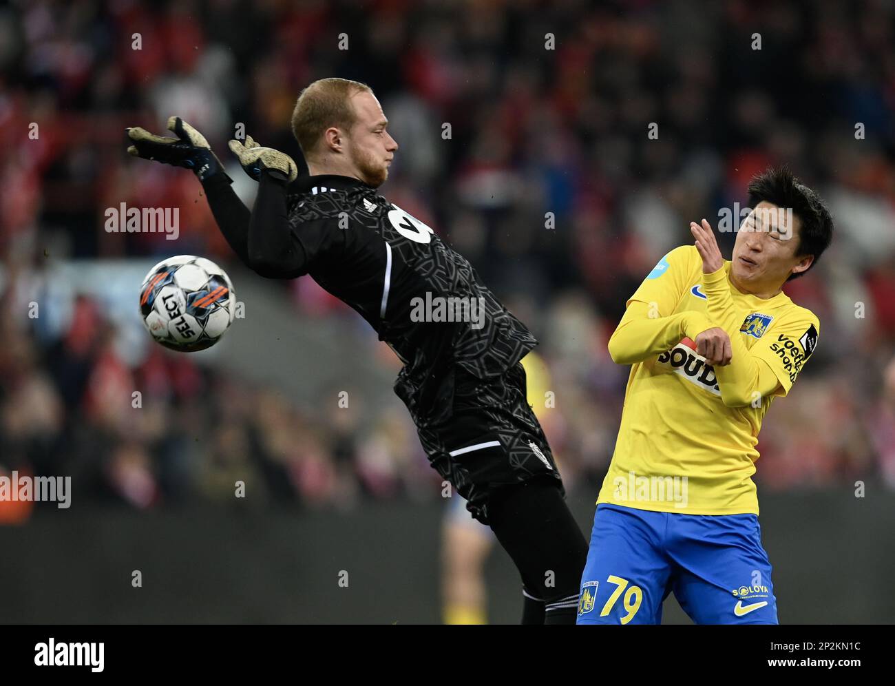 Standard's goalkeeper Arnaud Bodart and Westerlo's Yusuke Matsuo fight for the ball during a ...