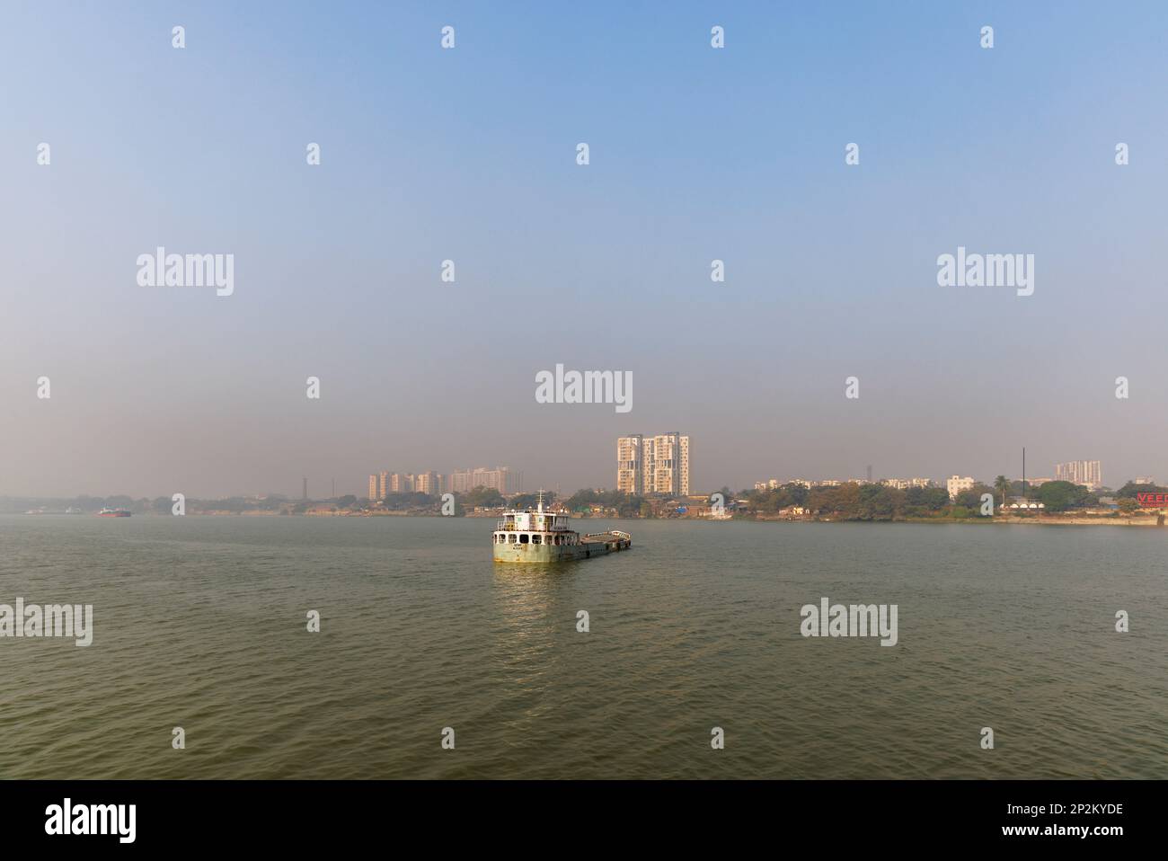 Boats moored and early morning smoggy atmosphere over the Hooghly River ...