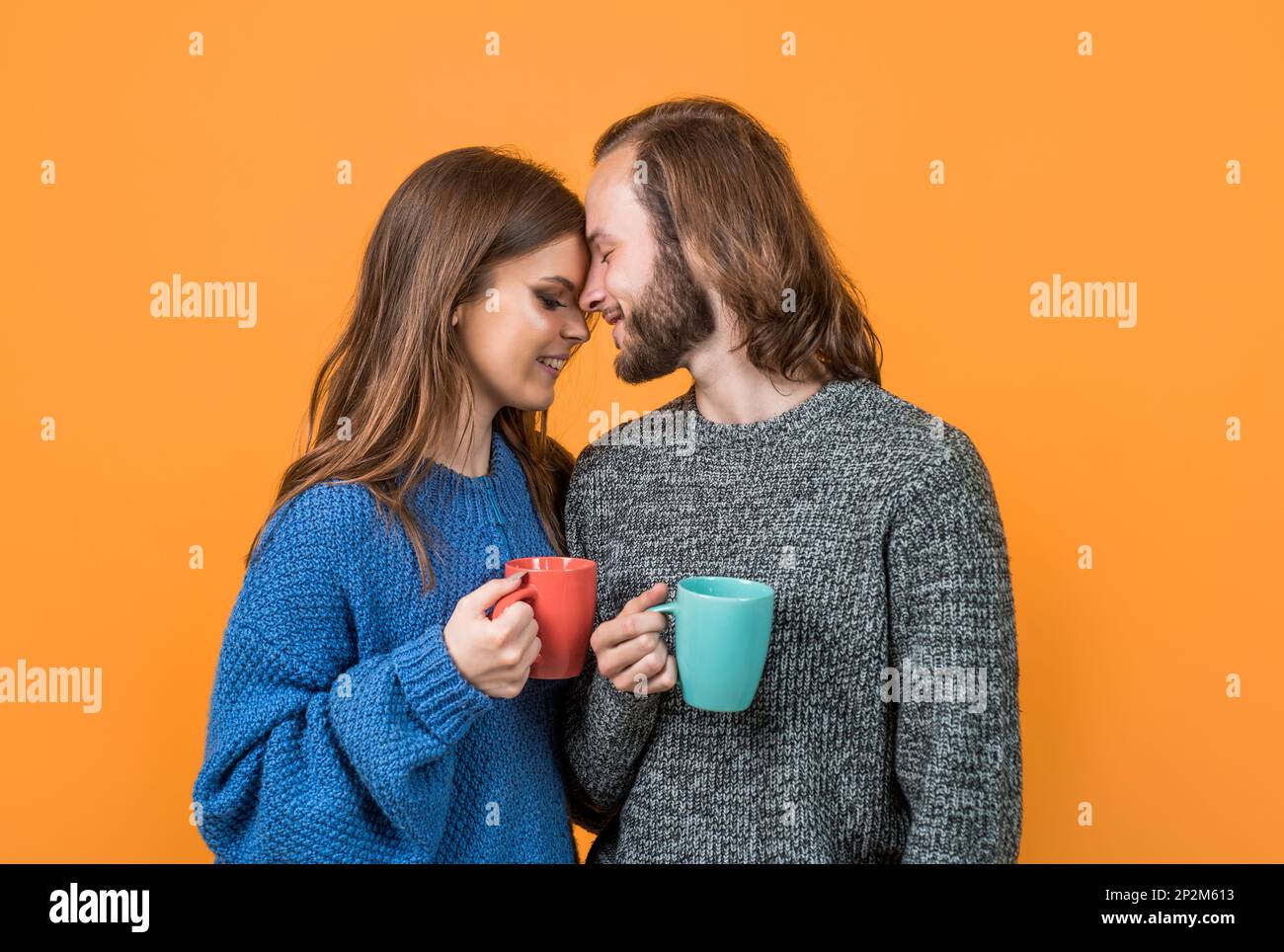 happy family couple wear knitted clothes in winter and drinking hot ...