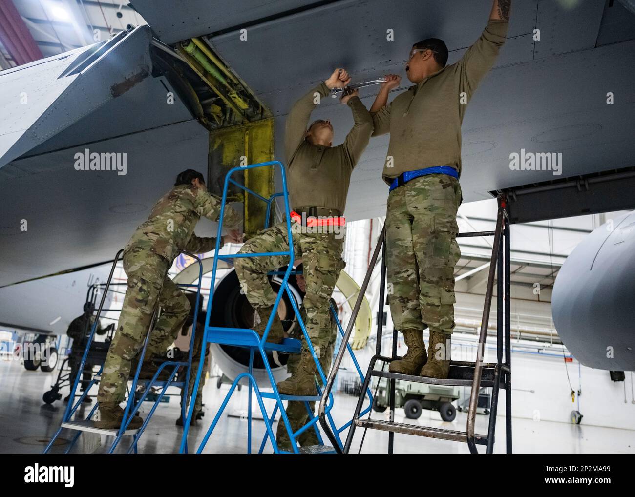U.S. Air Force Airmen assigned to the 100th Maintenance Squadron, extract screws from the wing ...