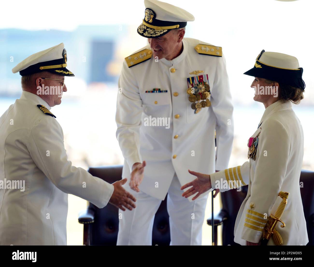 U.S. Navy Vice Adm. Wiliam Hilarides, center, congratulates Capt ...