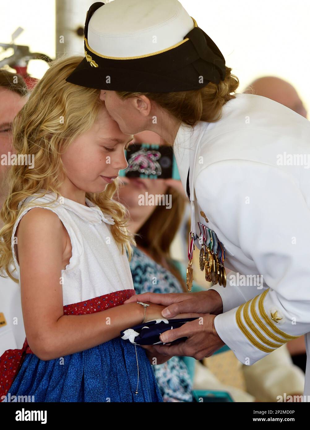 U.S. Navy Capt. Darlene Grasdock kisses her daughter Alexis, 9, after ...