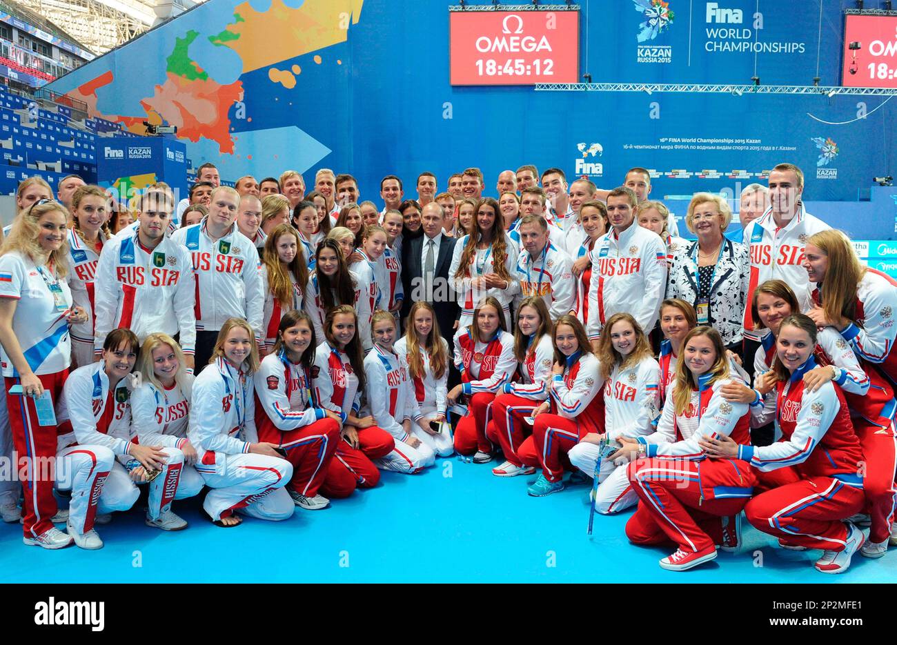 Russian President Vladimir Putin, centre, poses with Russian athletes ...