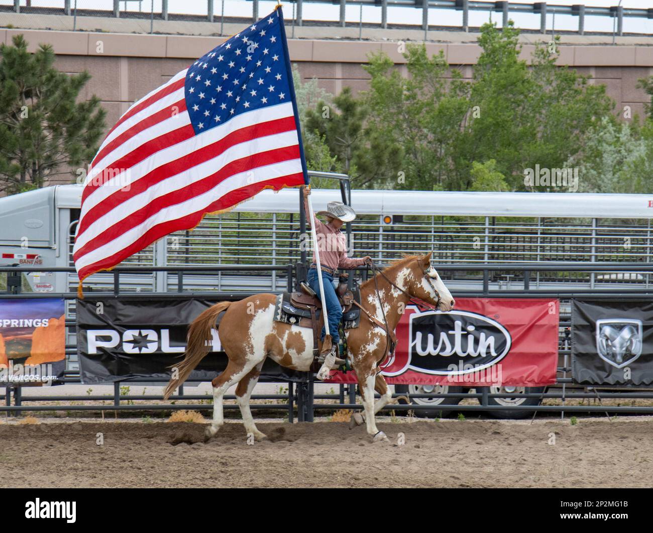 Traditional carry of American flag during opening of rodeo in Colorado ...